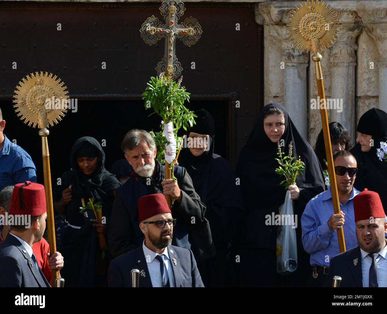 Greek Orthodox priests and nuns walking in a procession from the Tomb ...