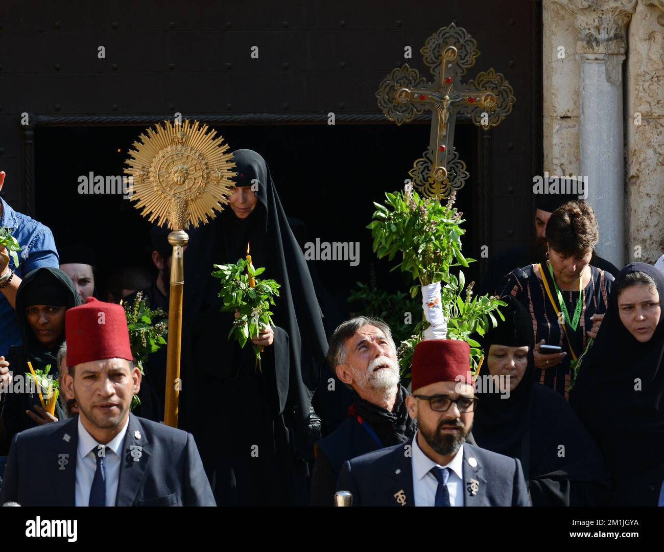 Greek Orthodox priests and nuns walking in a procession from the Tomb ...