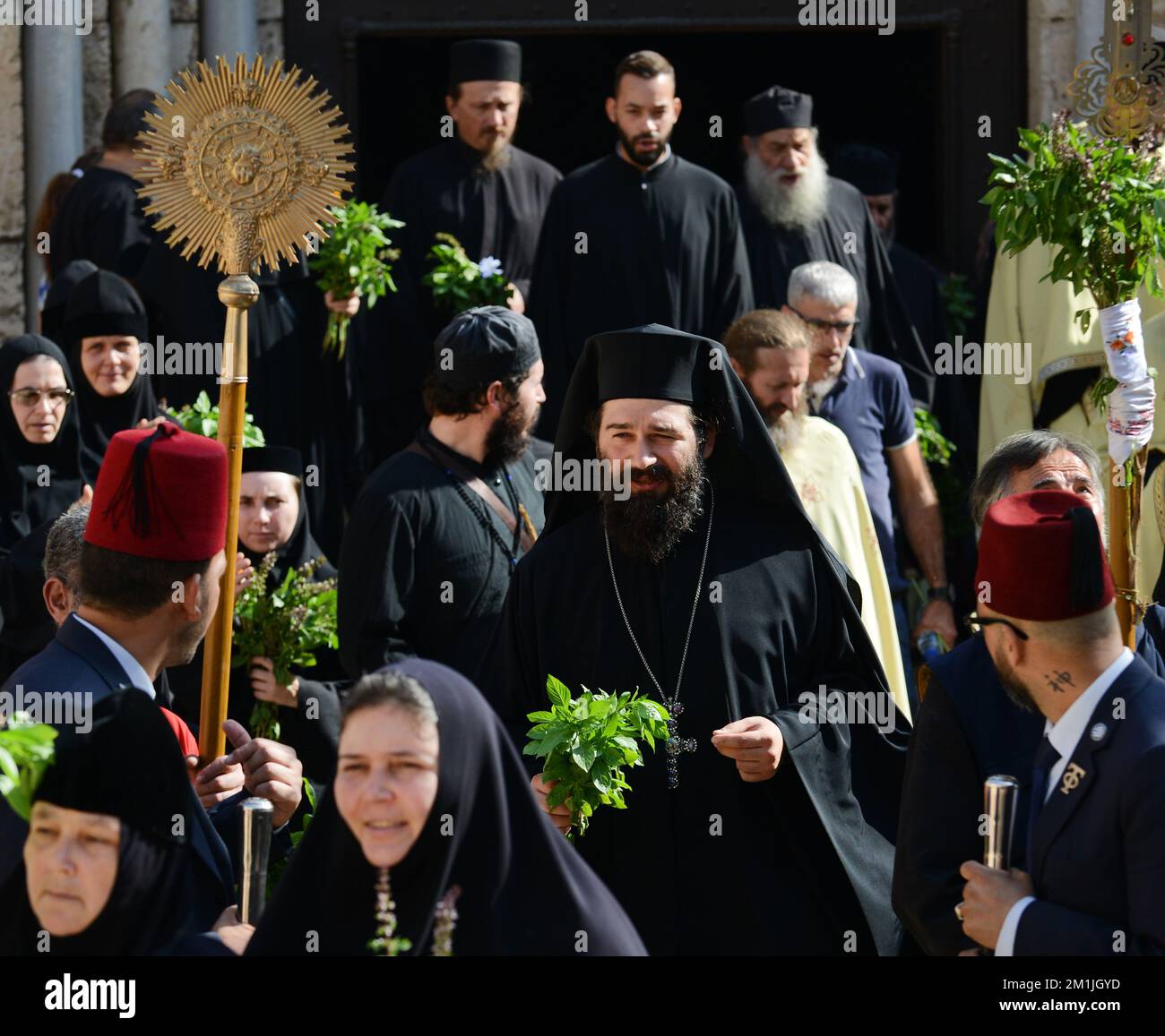 Greek Orthodox priests and nuns walking in a procession from the Tomb ...