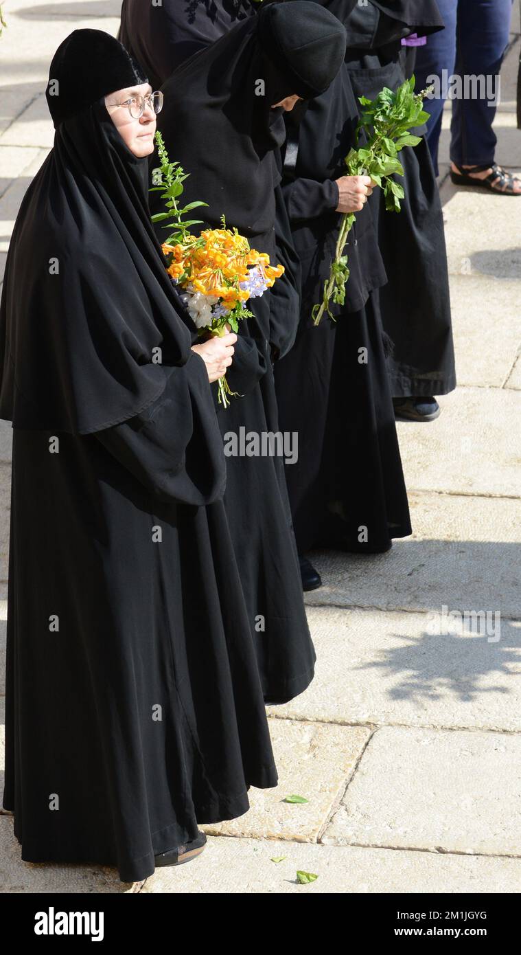 Greek Orthodox nuns walking in a procession from the Tomb off the ...