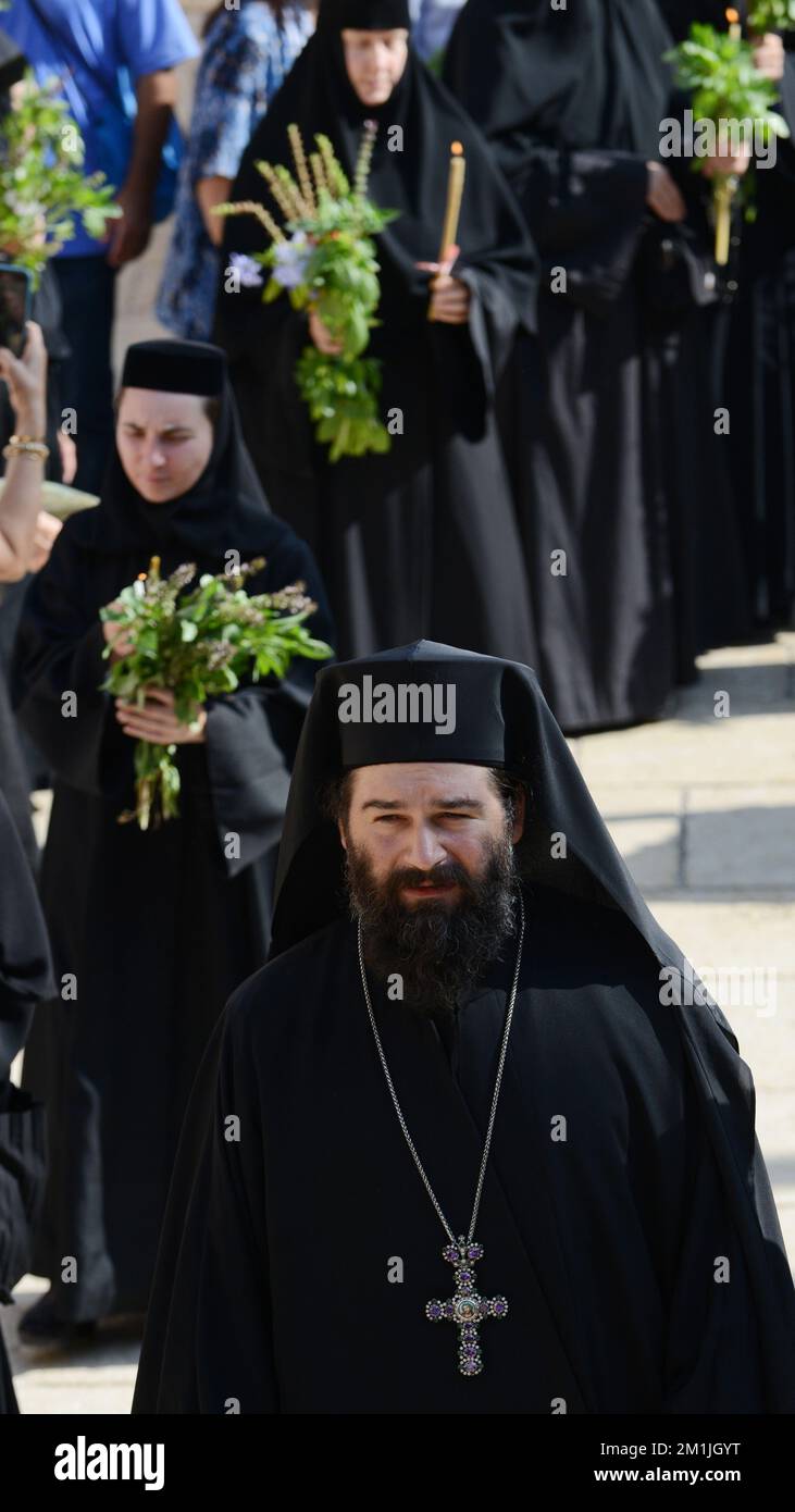 Greek Orthodox priests and nuns walking in a procession from the Tomb ...