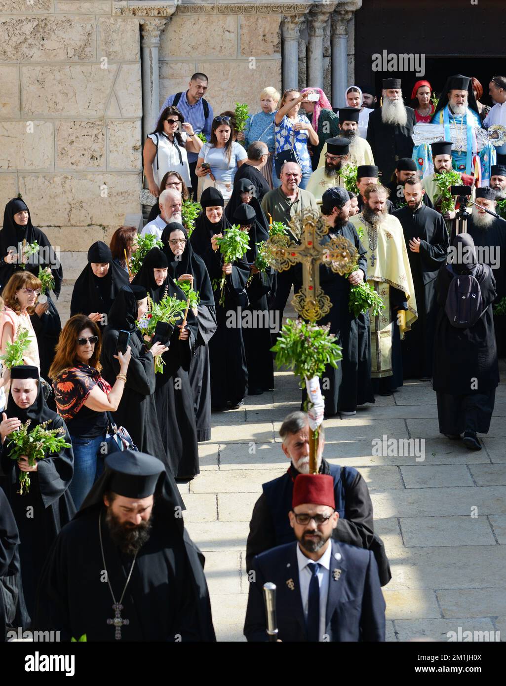 Greek Orthodox priests and nuns walking in a procession from the Tomb ...