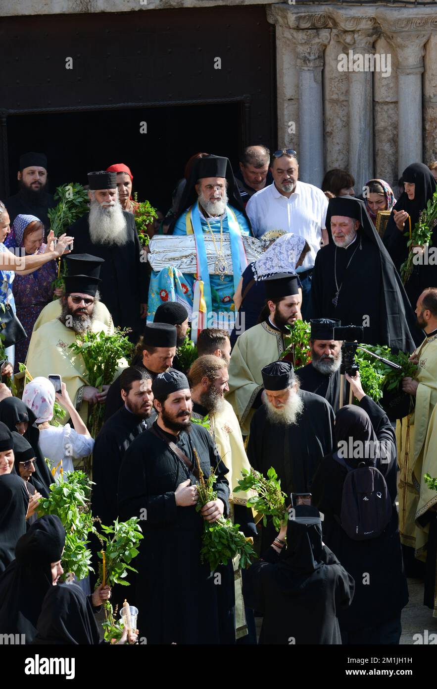 Greek Orthodox priests and nuns walking in a procession from the Tomb ...