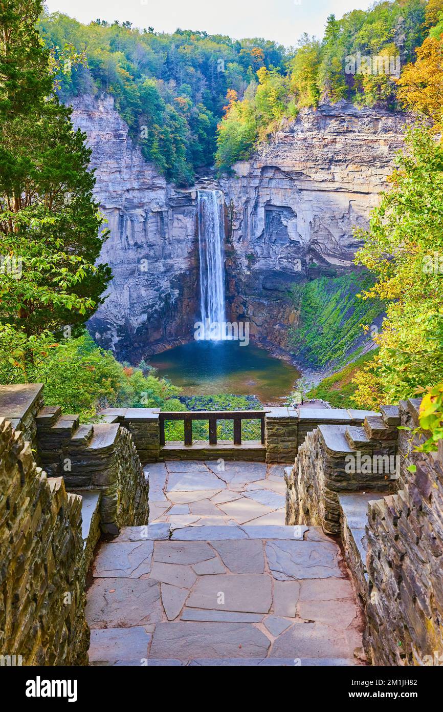 Stone steps lead to overlook of huge waterfall into canyon surrounded ...