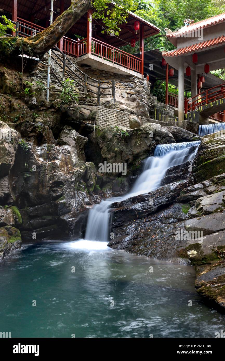 Cool spring water flows through the rocks in the rainforest. Long ...