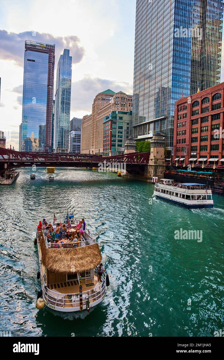 Tropical tourist ship through Chicago river canals by bridge lined with ...