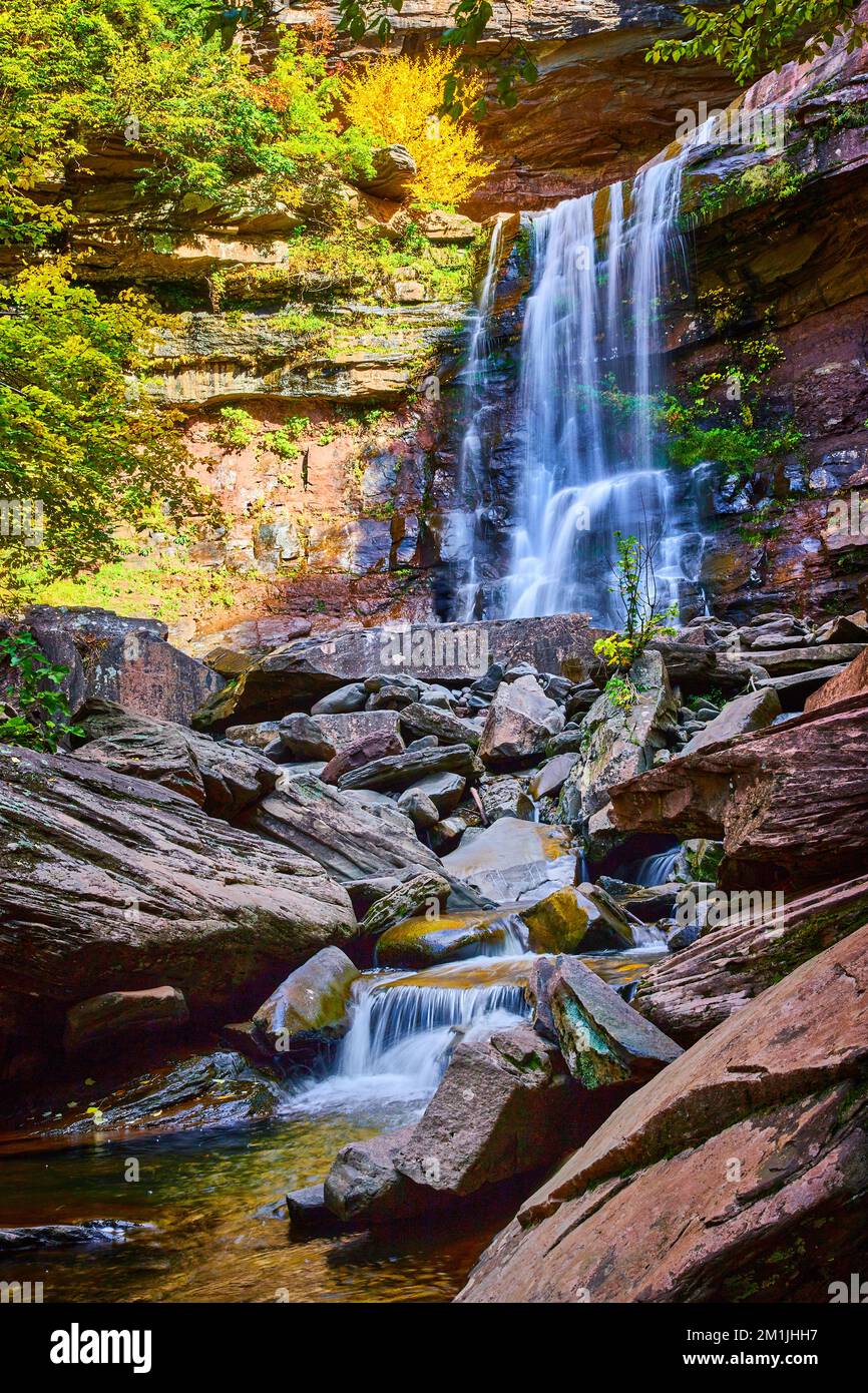 Large and small waterfalls pouring over cliff edges through rocky ...