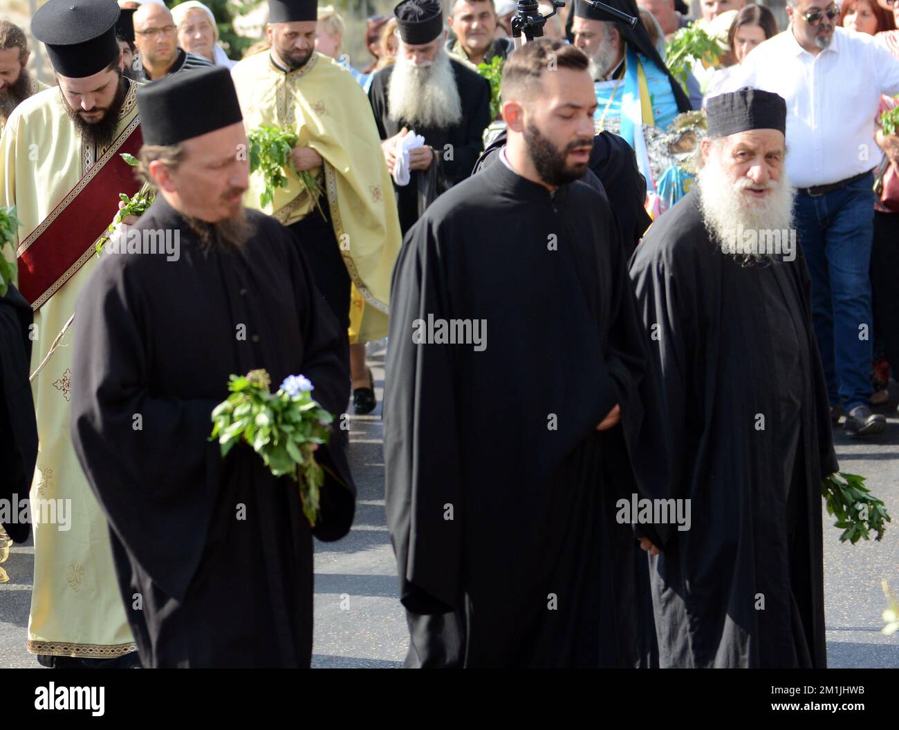Greek Orthodox priests and nuns walking in a procession from the Tomb ...