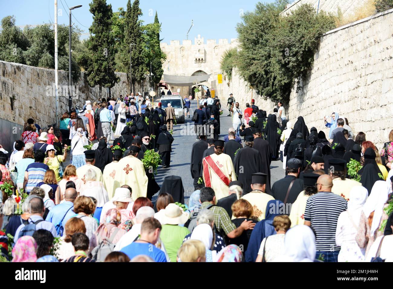 Greek Orthodox priests and nuns walking in a procession from the Tomb ...