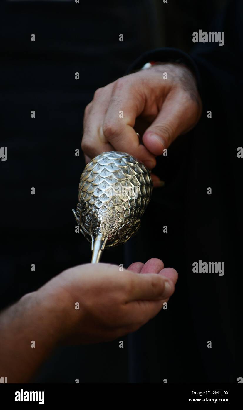 A Greek Orthodox priest Anointing Holy Oil from a traditional Silver ...
