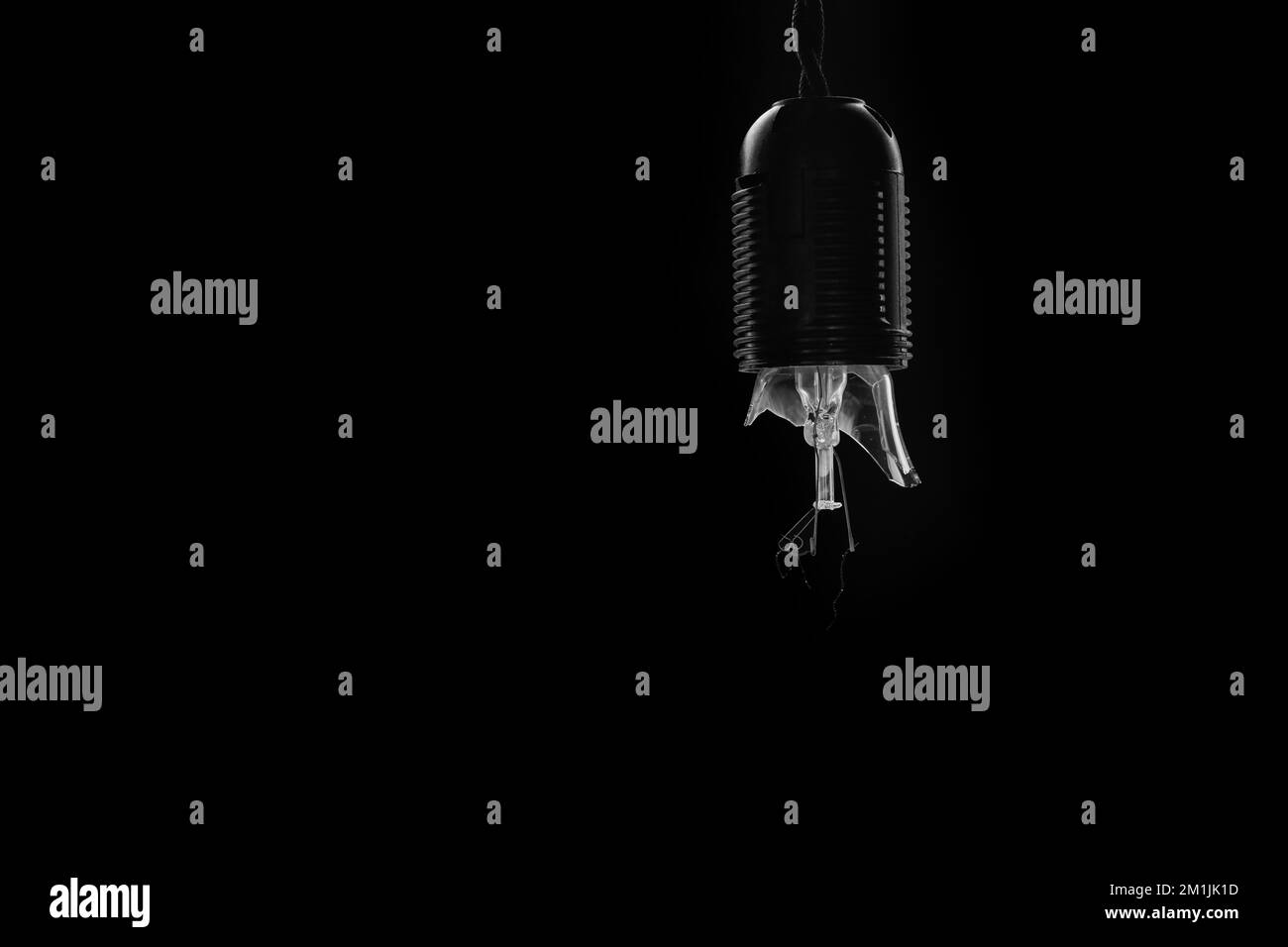 Broken light bulb against dark background Stock Photo - Alamy