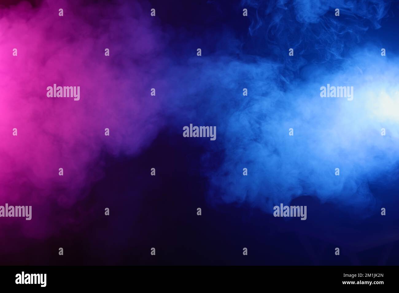 Pink and blue smoke on black background Stock Photo - Alamy