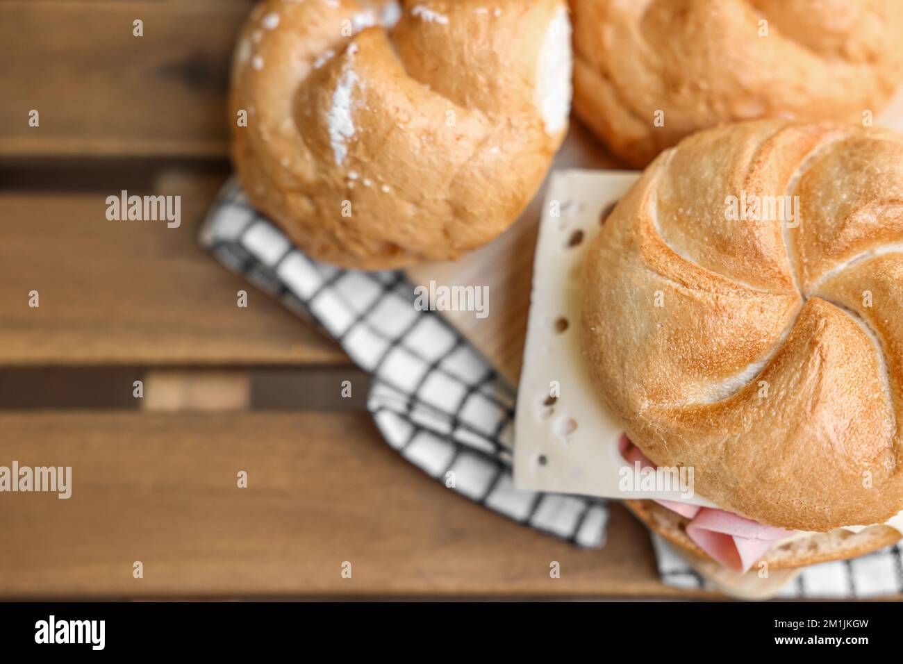 Kaiser rolls with ham and cheese on wooden board Stock Photo - Alamy