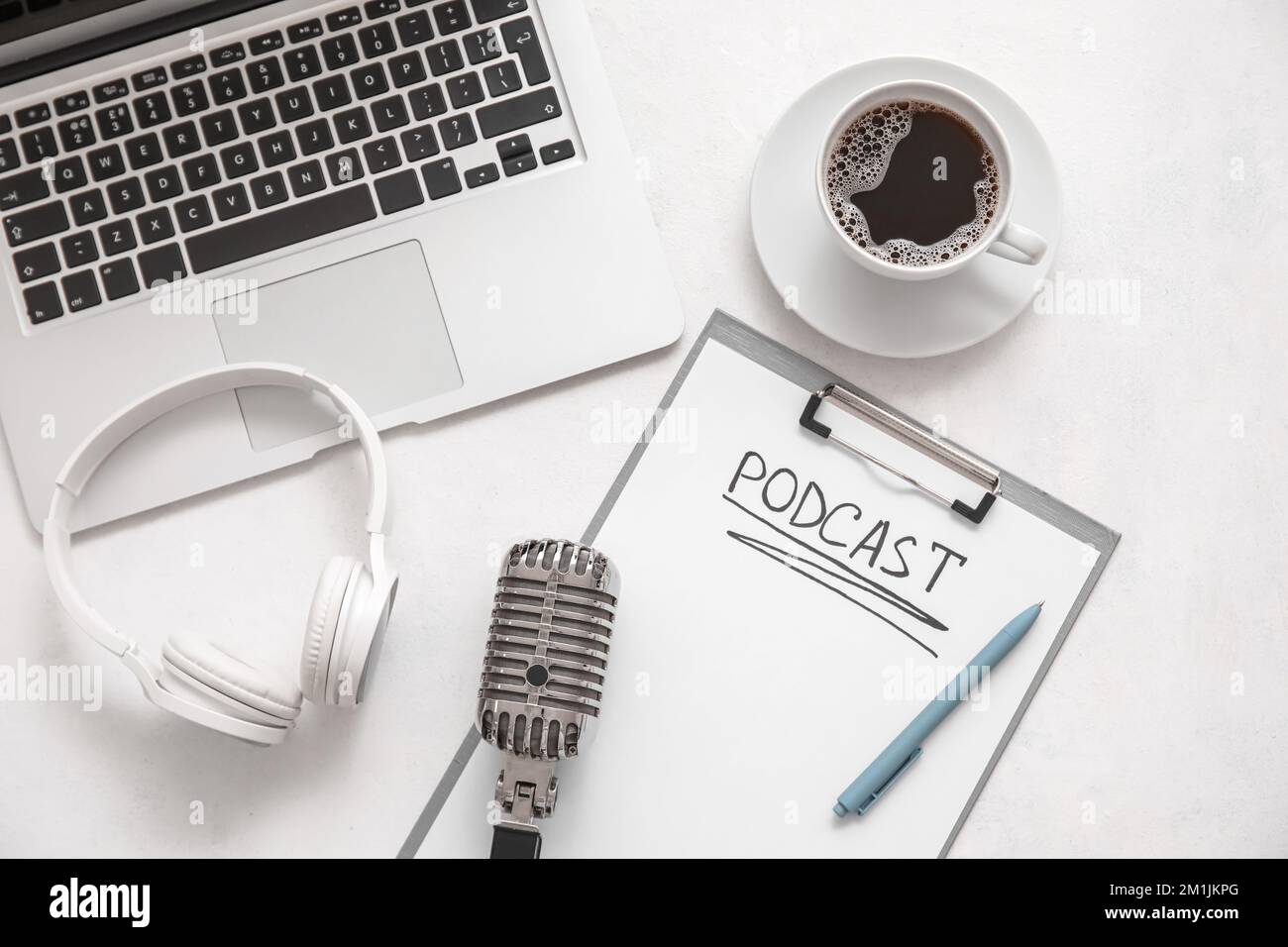 Clipboard with word PODCAST, microphone, headphones, laptop and coffee ...