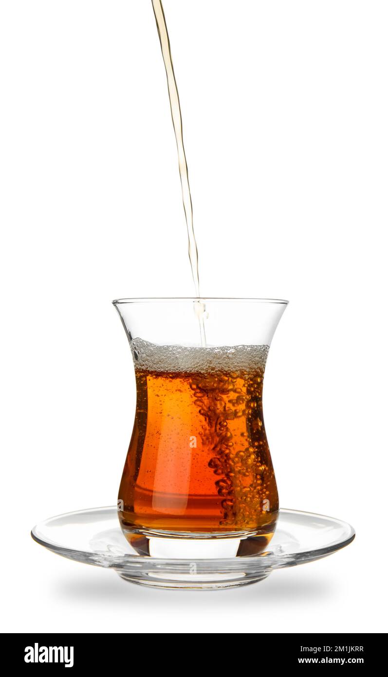 Pouring of Turkish tea into glass on white background Stock Photo - Alamy