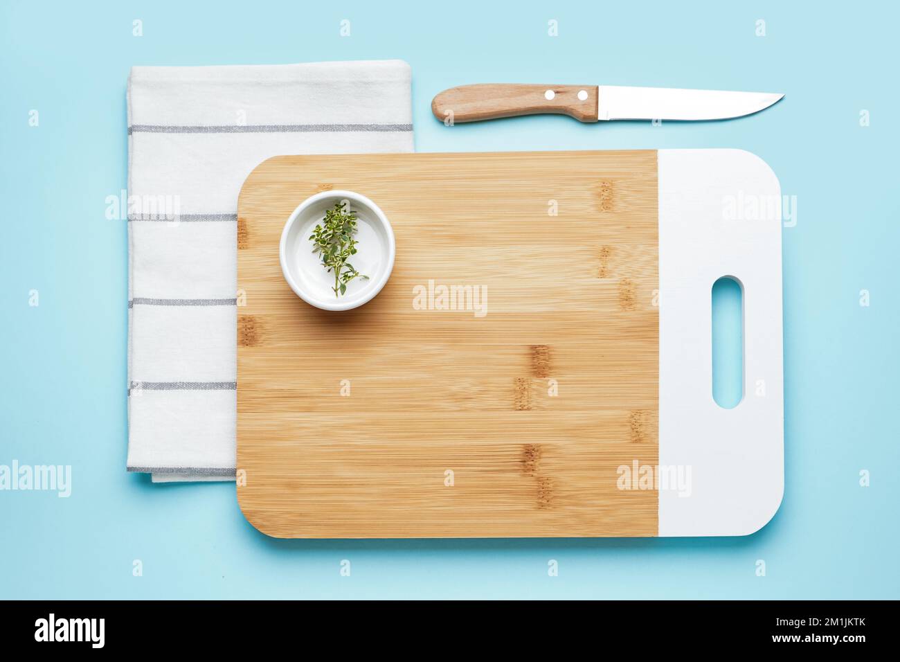 Clean cutting board and towel on blue background Stock Photo - Alamy