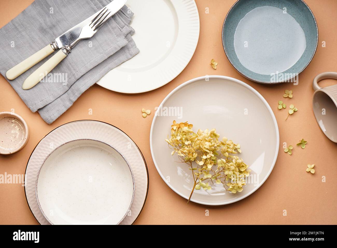 Different clean dinnerware on beige background Stock Photo - Alamy