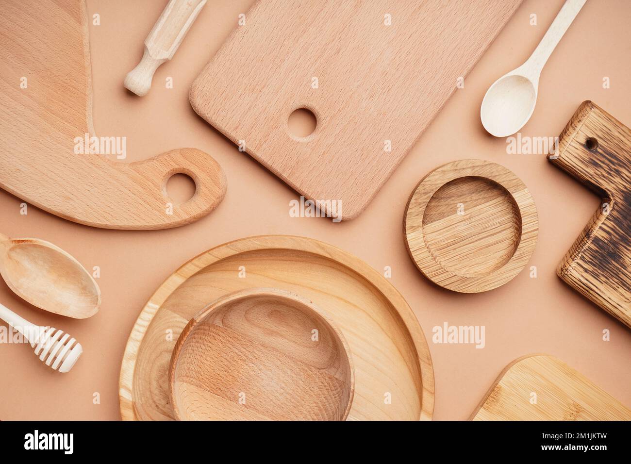 Wooden cooking utensils on beige background Stock Photo - Alamy