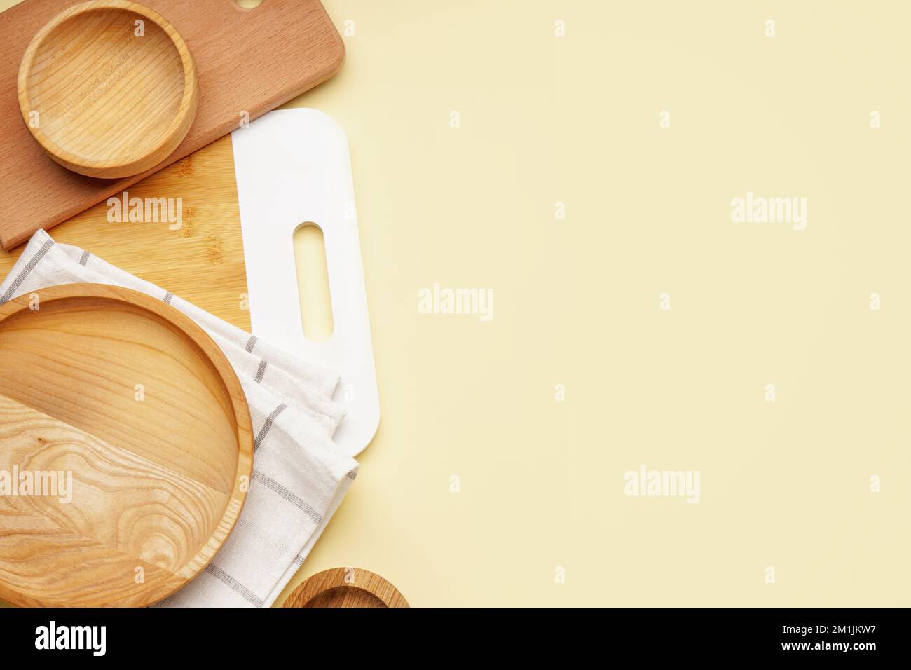 Wooden plates and boards on yellow background Stock Photo - Alamy