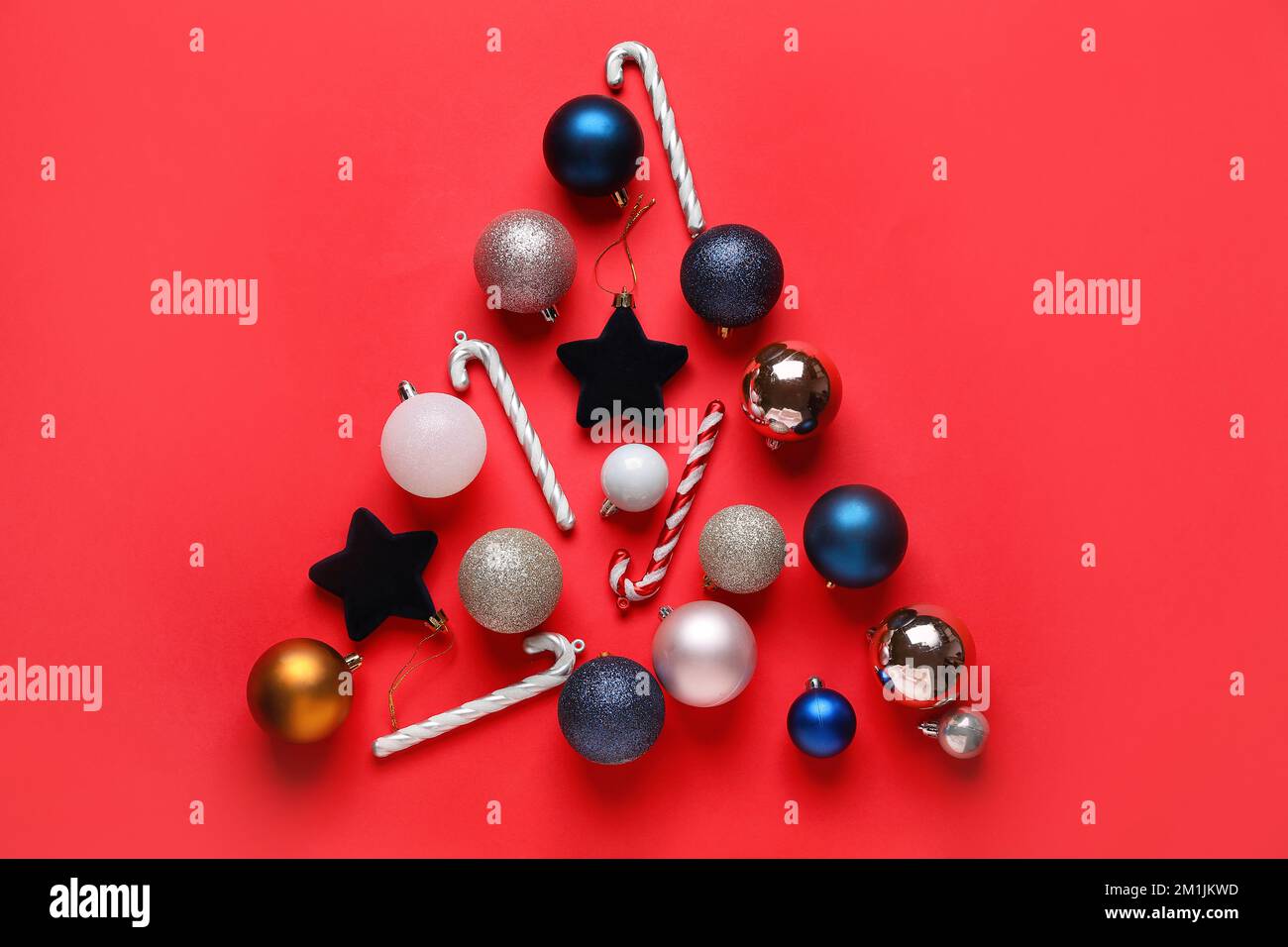 Christmas tree made of decor on red background, top view Stock Photo ...