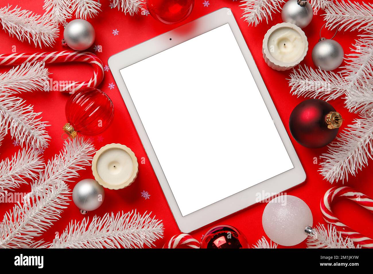 Blank tablet computer with Christmas decor on red background Stock ...