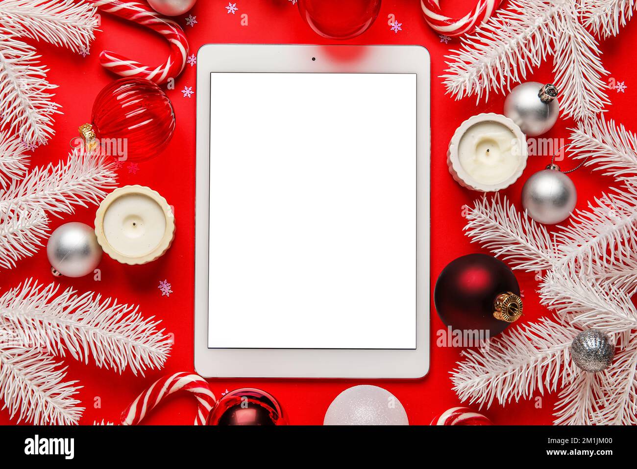 Blank tablet computer with Christmas decor on red background Stock ...