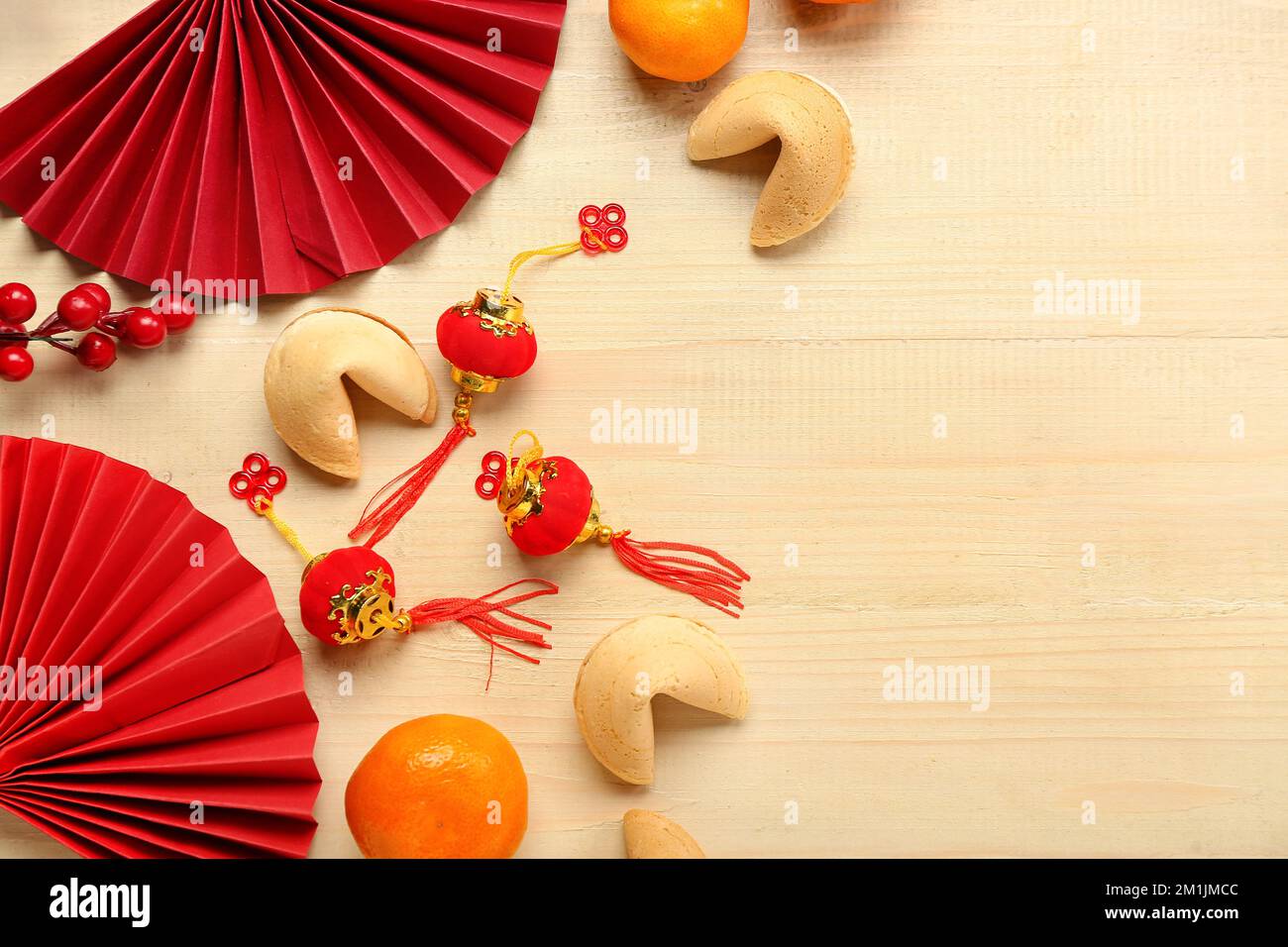 Fortune cookies, mandarins and Chinese symbols on wooden background ...