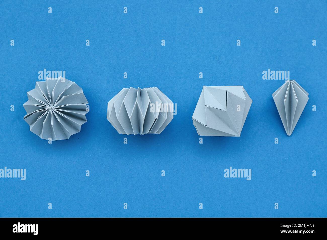 Paper Christmas balls on blue background Stock Photo - Alamy