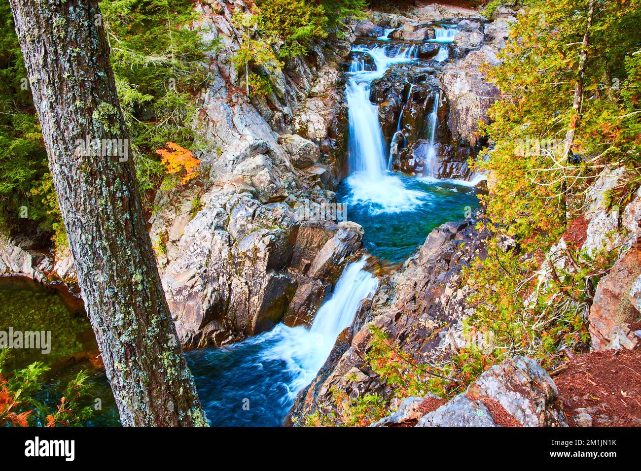 Stunning serene cascading blue waterfalls into buckets along rocky ...