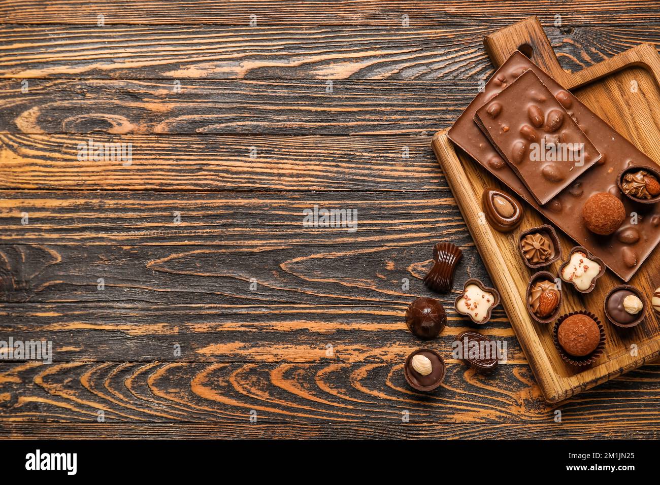 Board with chocolate bars and candies on wooden background Stock Photo ...