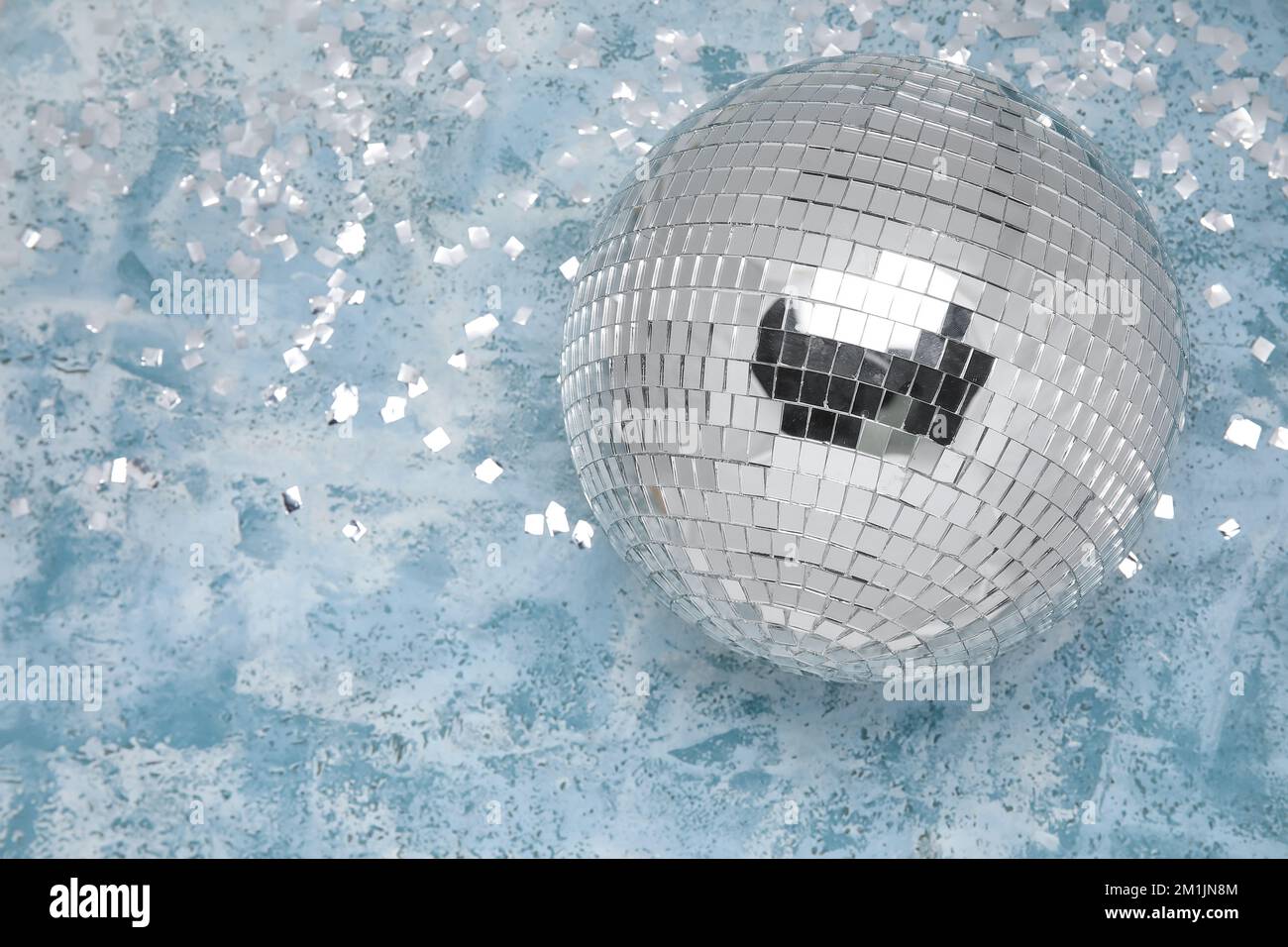 Disco ball with confetti on grunge background Stock Photo - Alamy