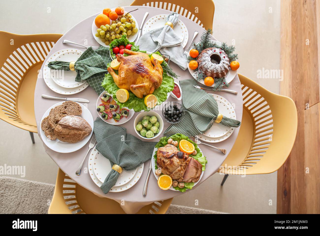 Christmas table setting with tasty meat and cake in dining room, top ...