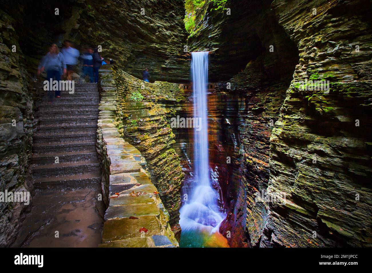 Stone steps lead around and beyond amazing waterfall in gorge of ...