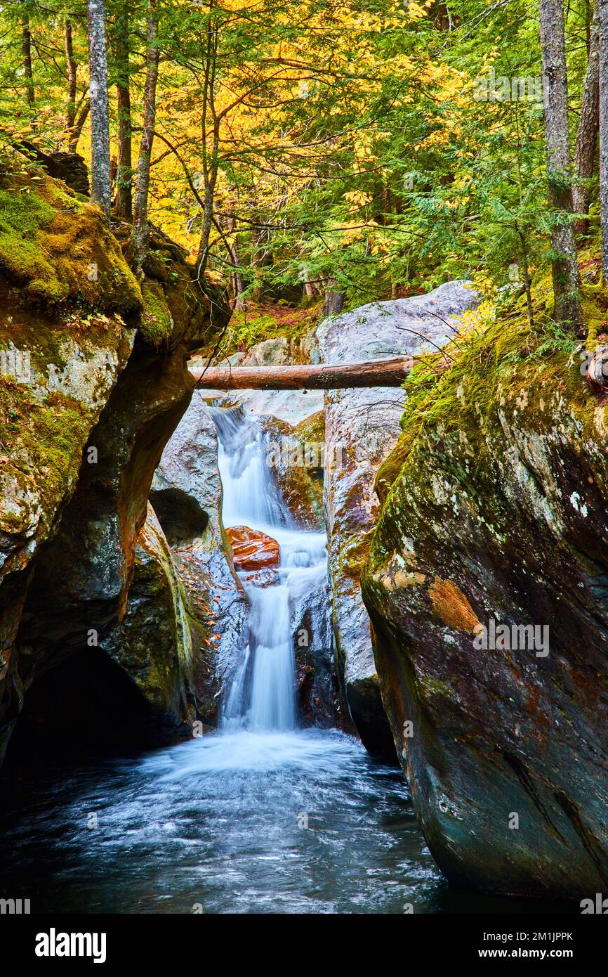 Stunning waterfall pouring through narrow mossy gorge in beautiful ...