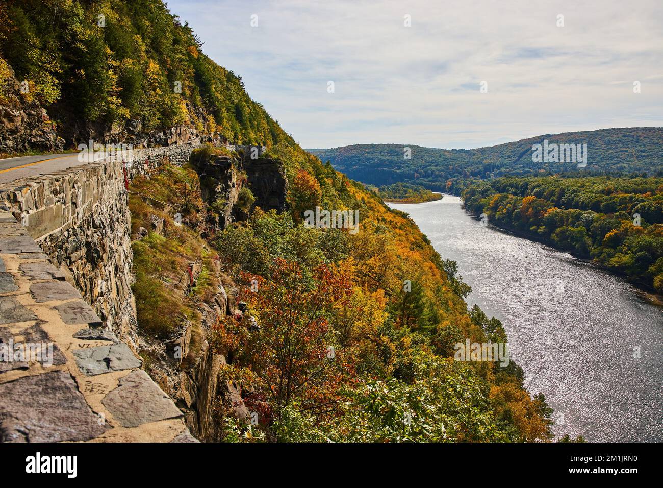 Stone wall and road wind through cliffs and mountains next to Delaware ...