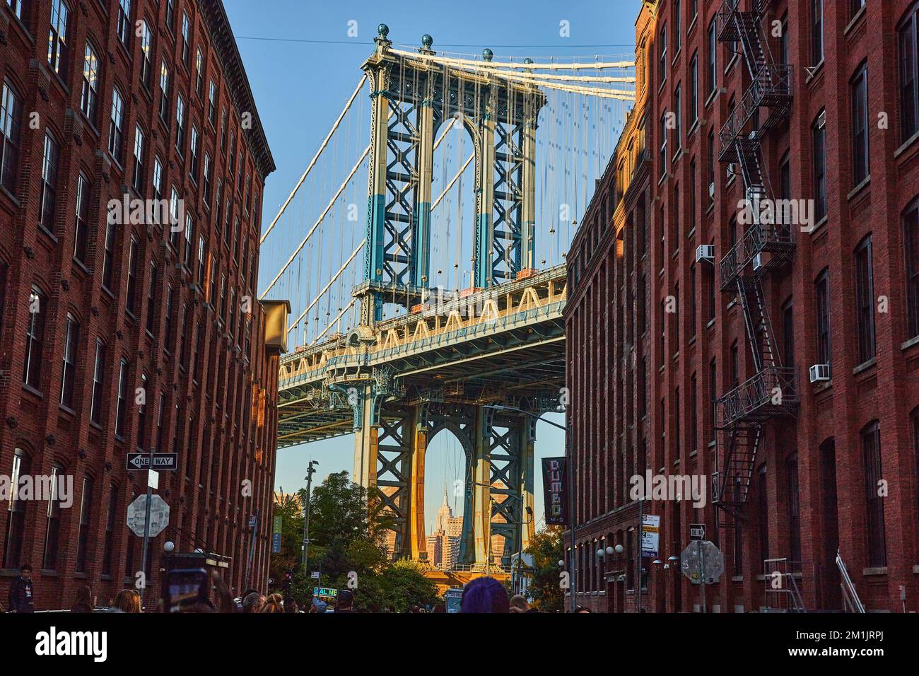 Brooklyn view of Manhattan Bridge in center of street with two large ...