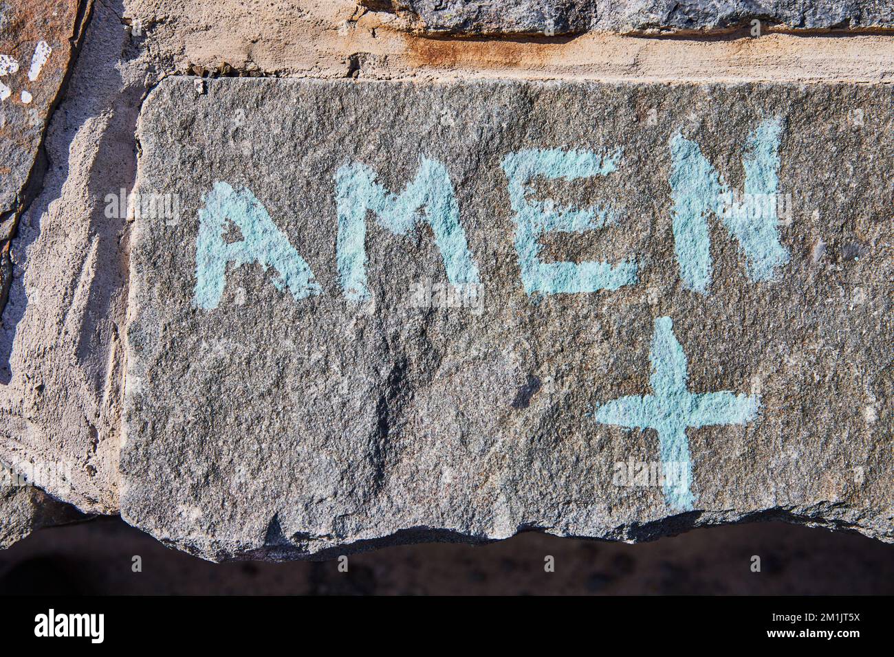Detail of stone wall graffiti from above Amen and Christian Cross ...