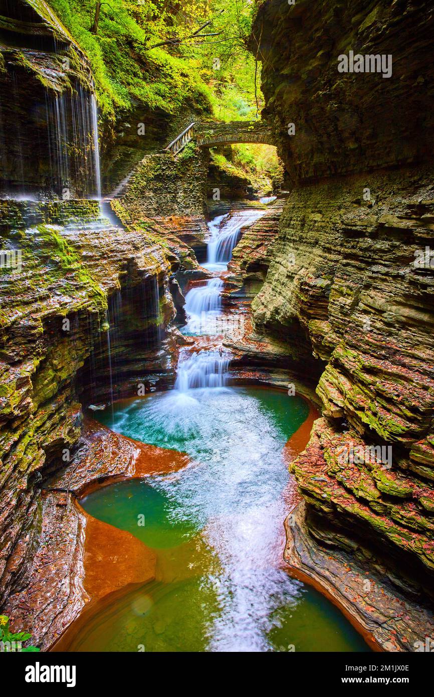 Stone bridge and trail around and over stunning waterfall gorge with ...