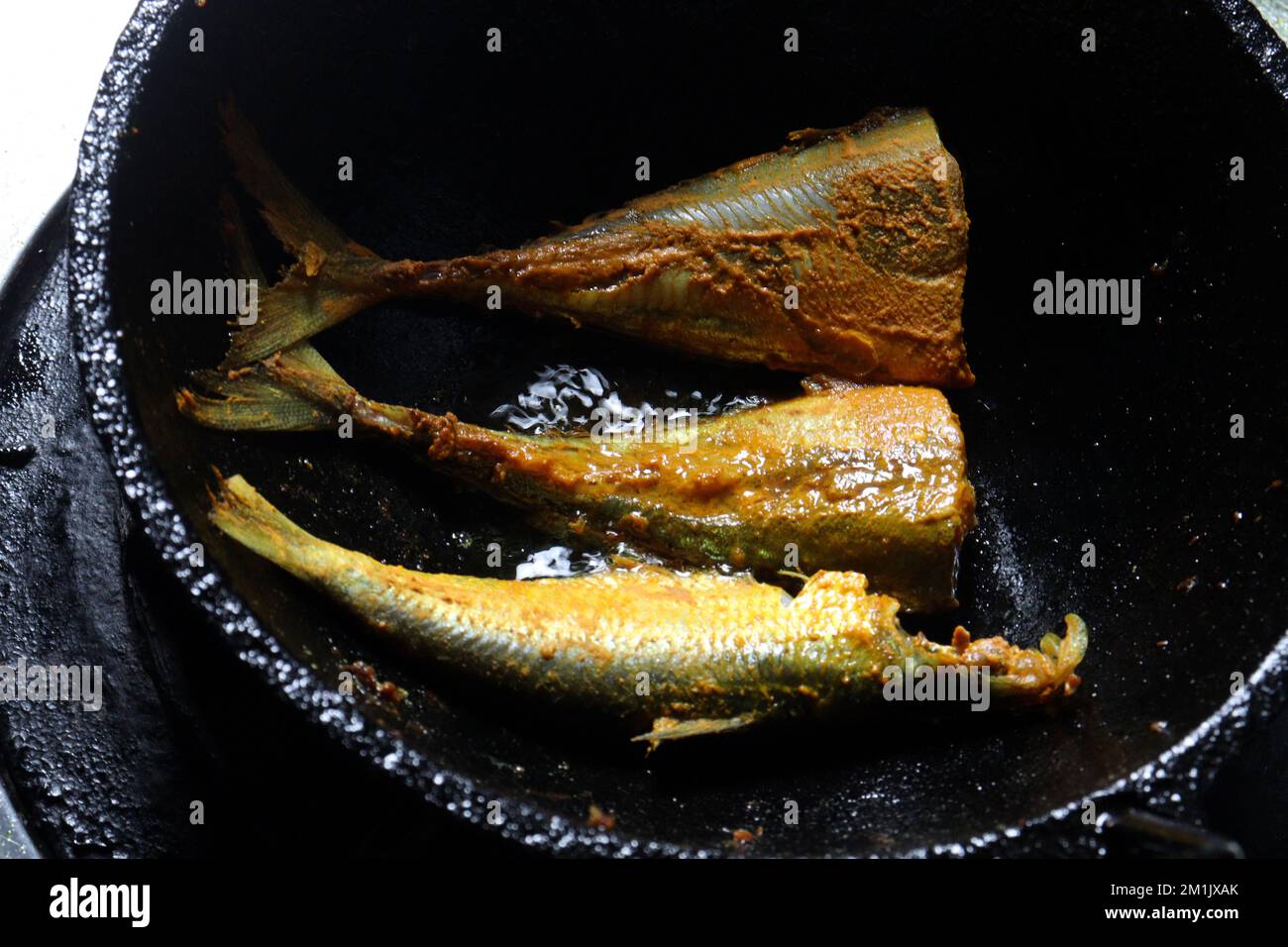 tasty and healthy sea fried fish with spice and oil on iron pan Stock ...