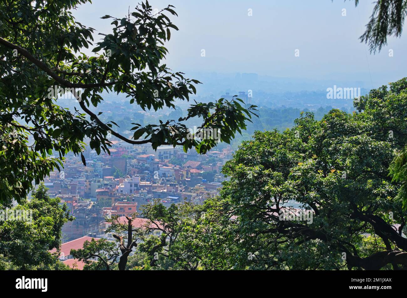 Panoramic view of the Kathmandu in Nepal through the tree branches ...