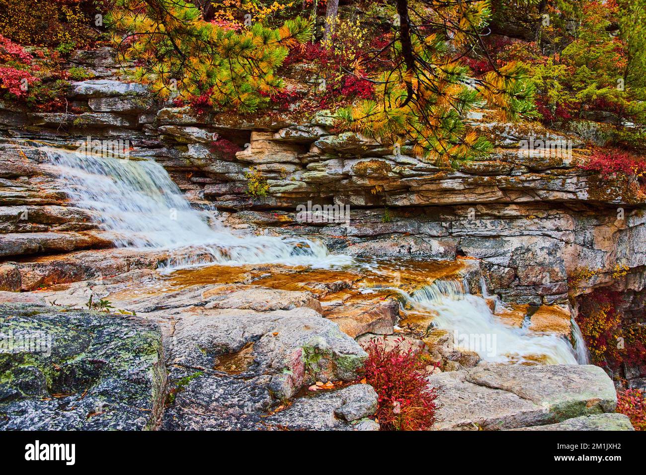 Beautiful layers of rocks in river with cascading waterfalls and fall ...