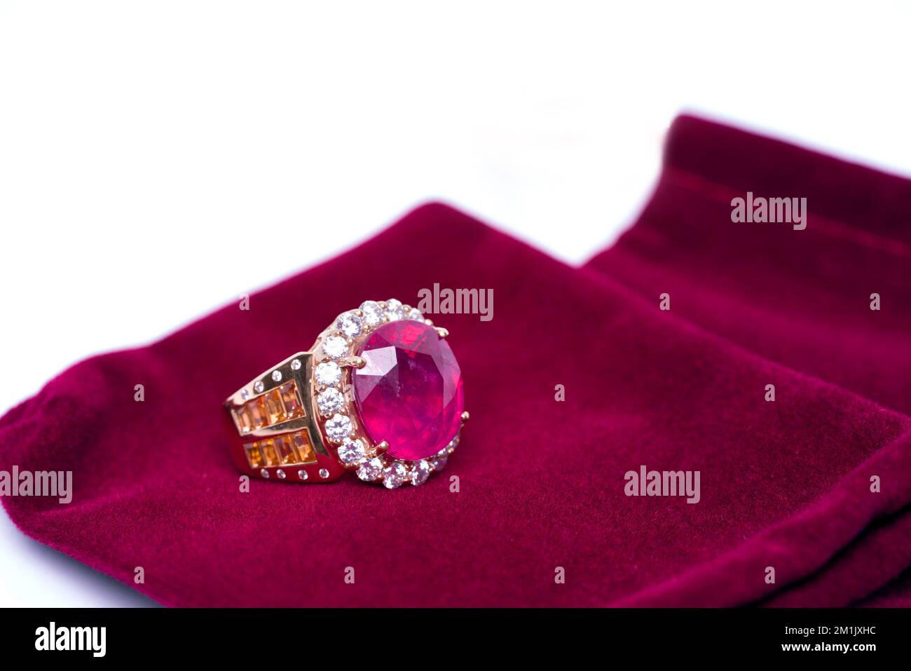 Burma Ruby with orange sapphires and white quartz ring on red velvet ...