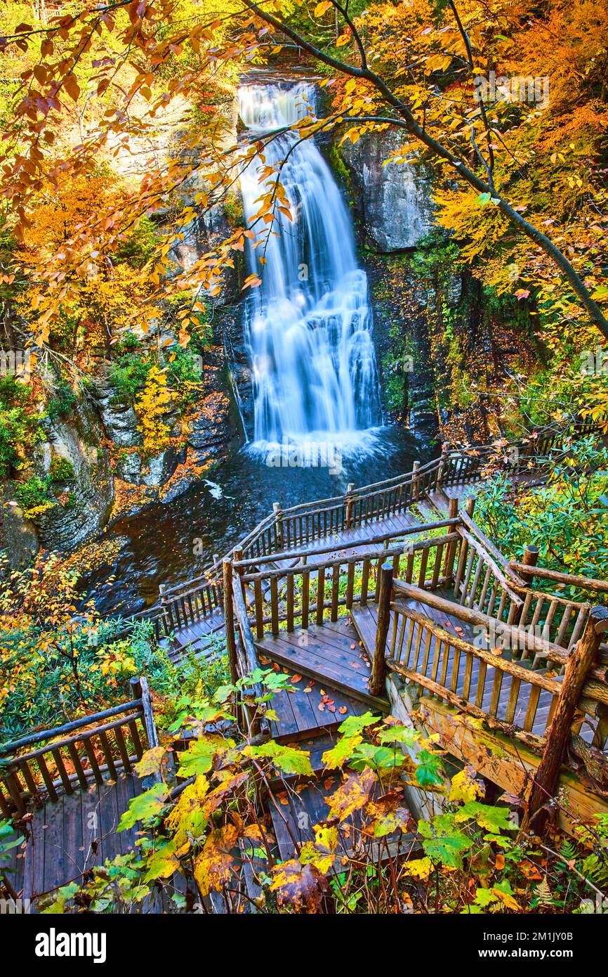 Boardwalk stairs lead down to stunning large waterfall over cliffs ...