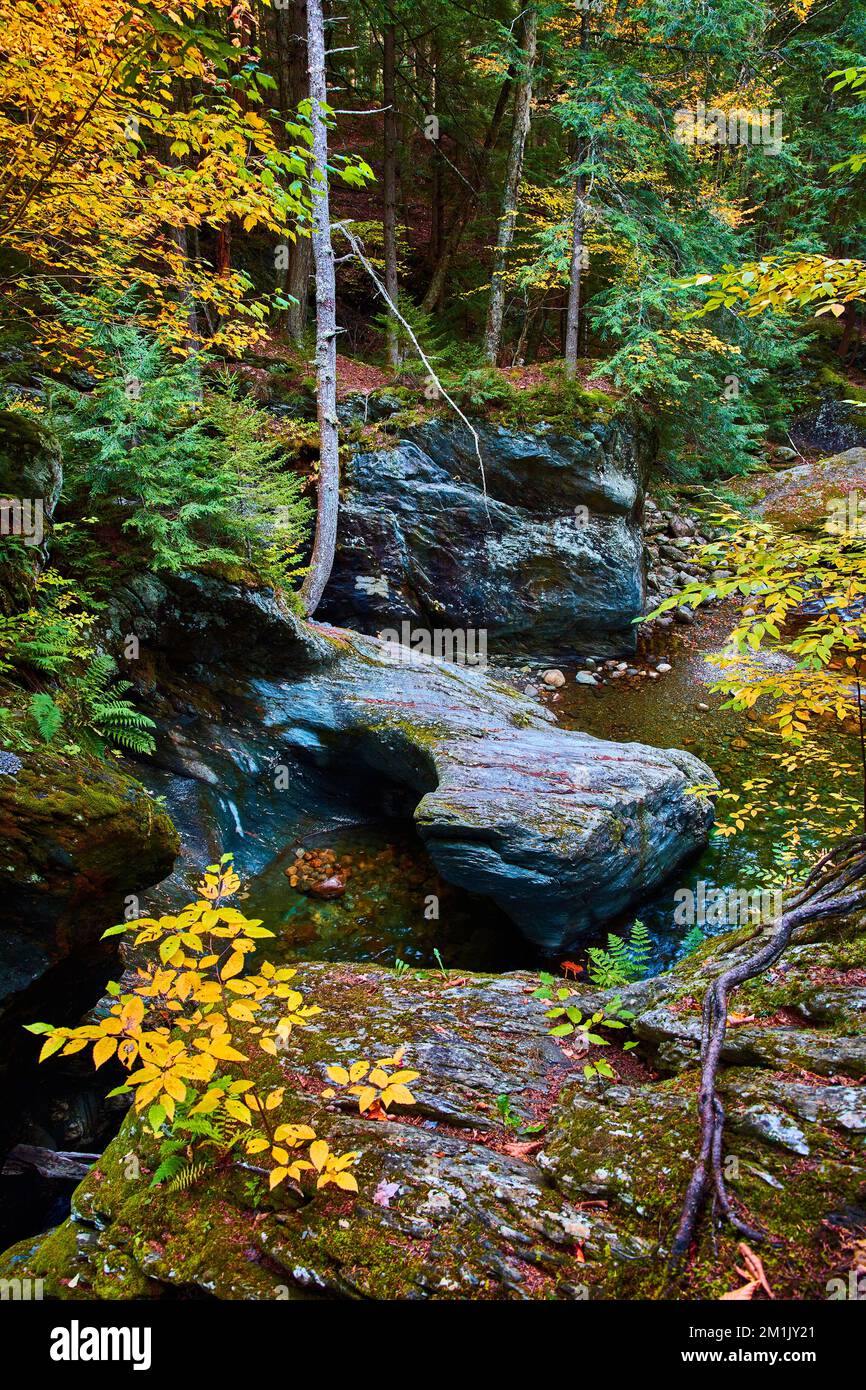 Beautiful rock with circle carved out of it along fall river gorge from ...