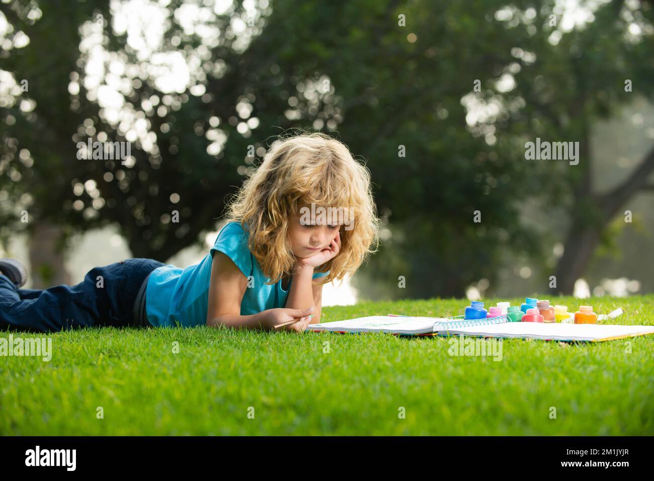 Child drawing. Portrait of smiling happy kid enjoying art and craft ...