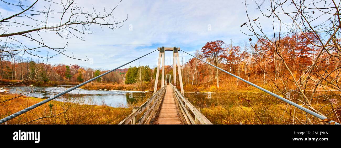 Panorama of long suspension bridge going over Michigan river with fall ...