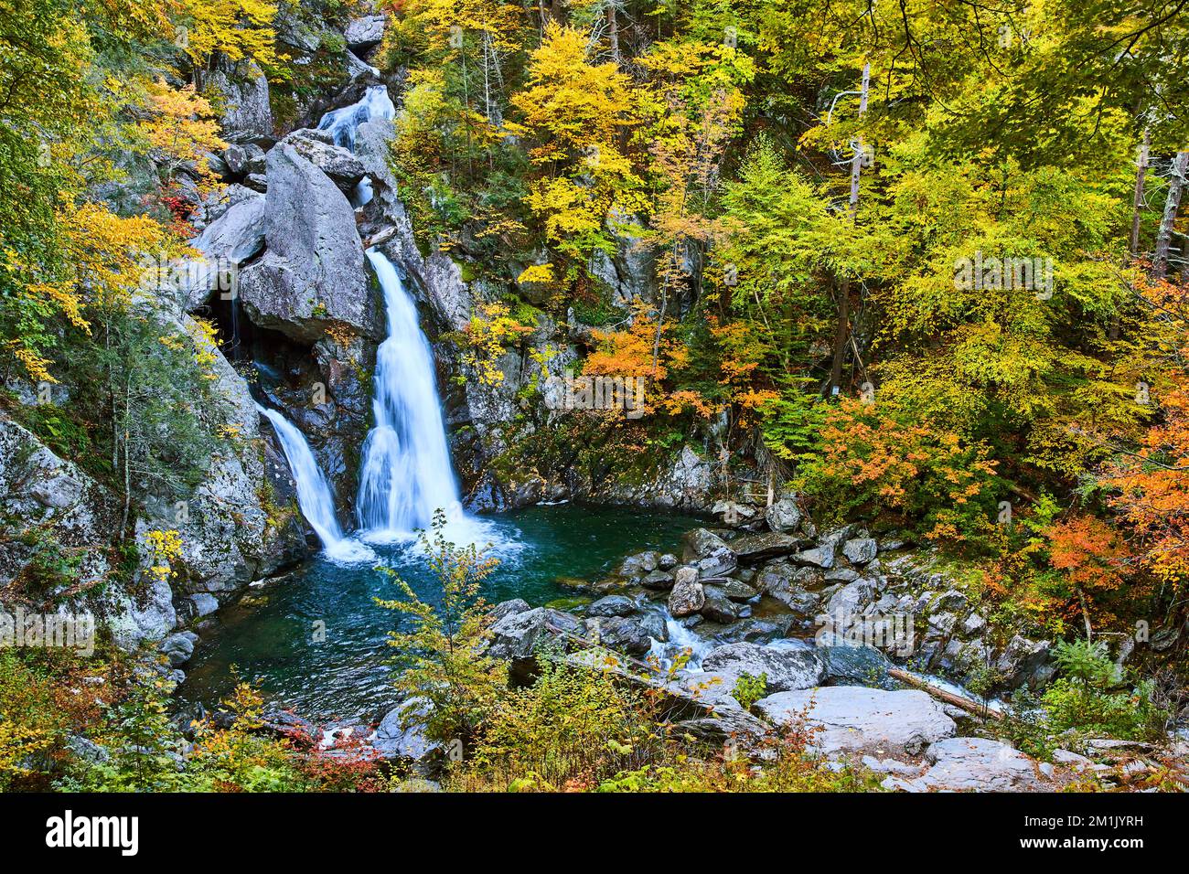 Magical blue waterfall in New York fall with yellow foliage Stock Photo ...