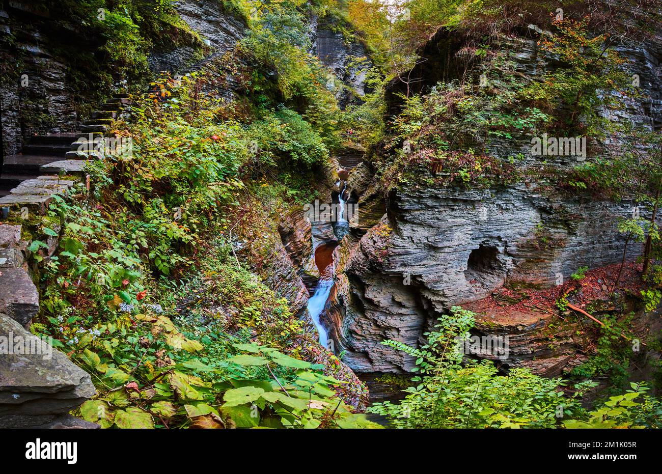 Wide view of trail along winding gorge with river, waterfalls, and ...