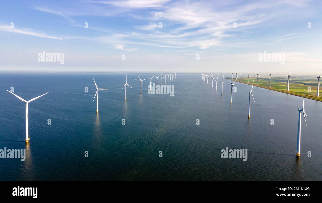 Drone Aerial view at Windmill park with windmills turbines in the ocean ...