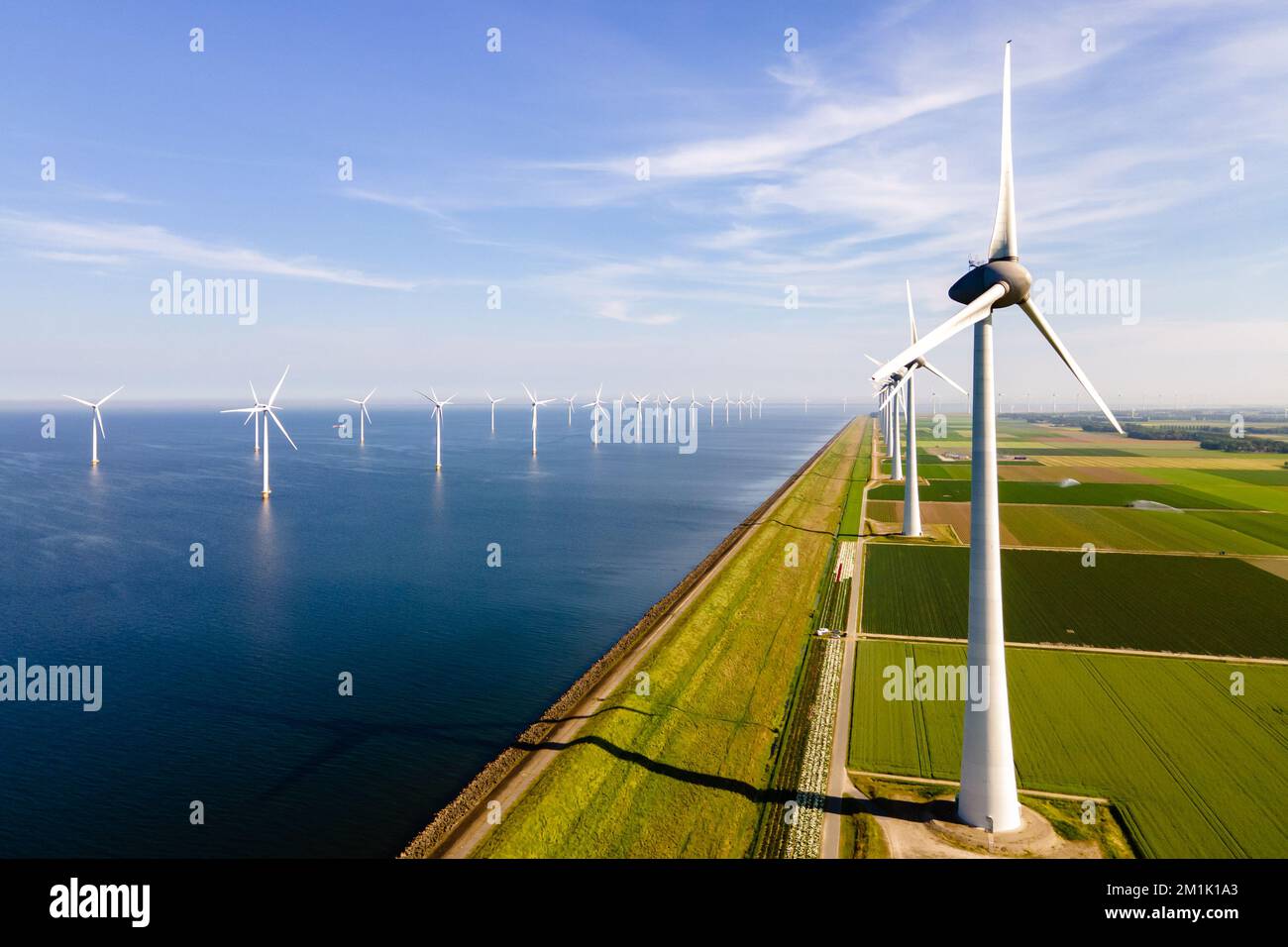 Drone Aerial view at Windmill park with windmills turbines in the ocean ...